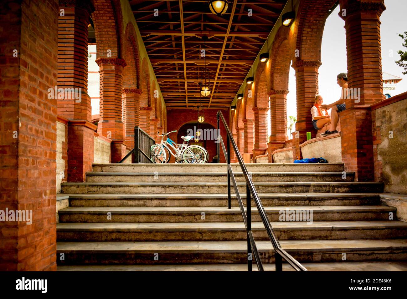 Steps lead up to bicycles and Young people having a chat along the ...