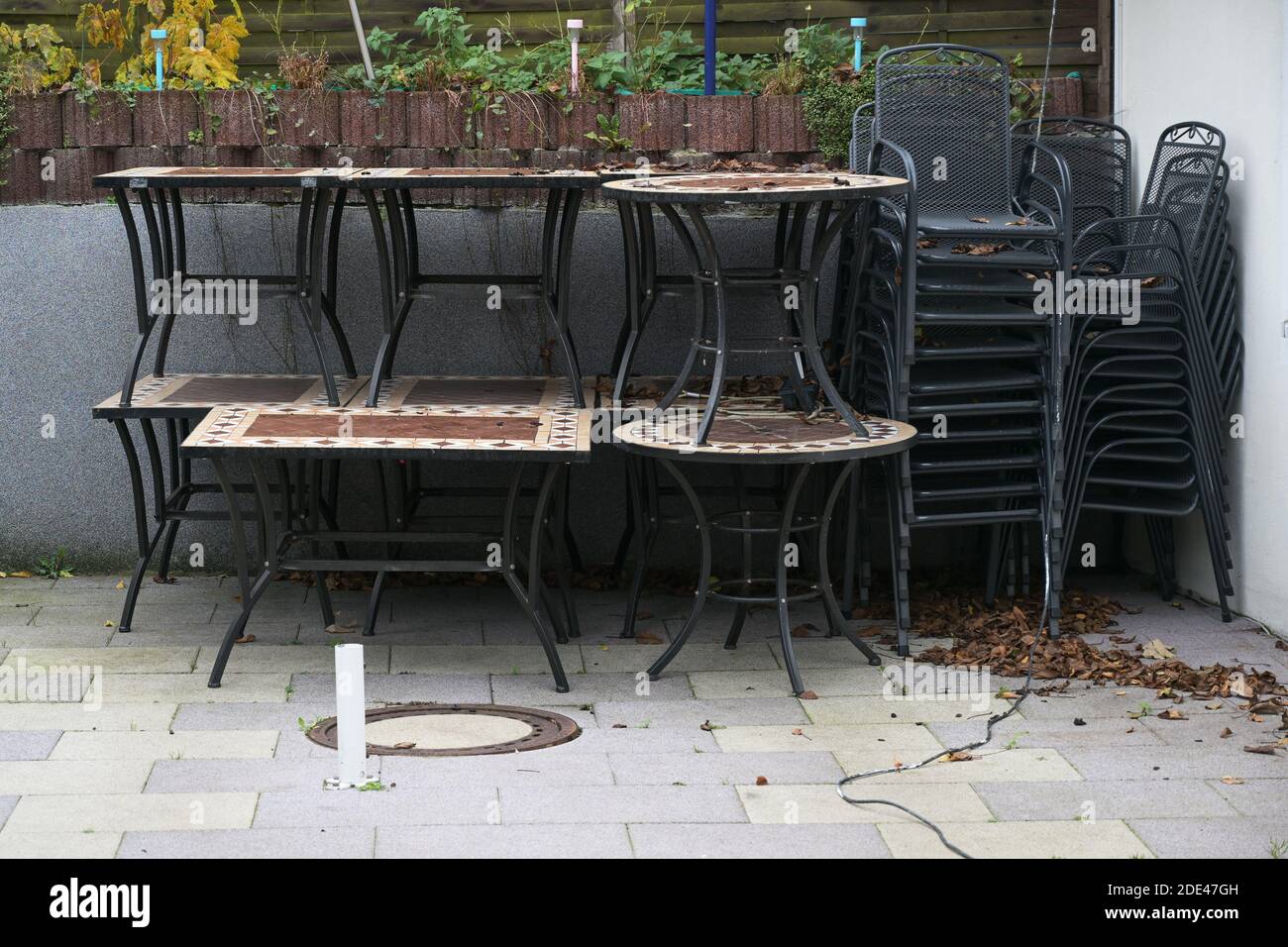 Stacked tables and chairs on the restaurant terrace during lockdown due ...