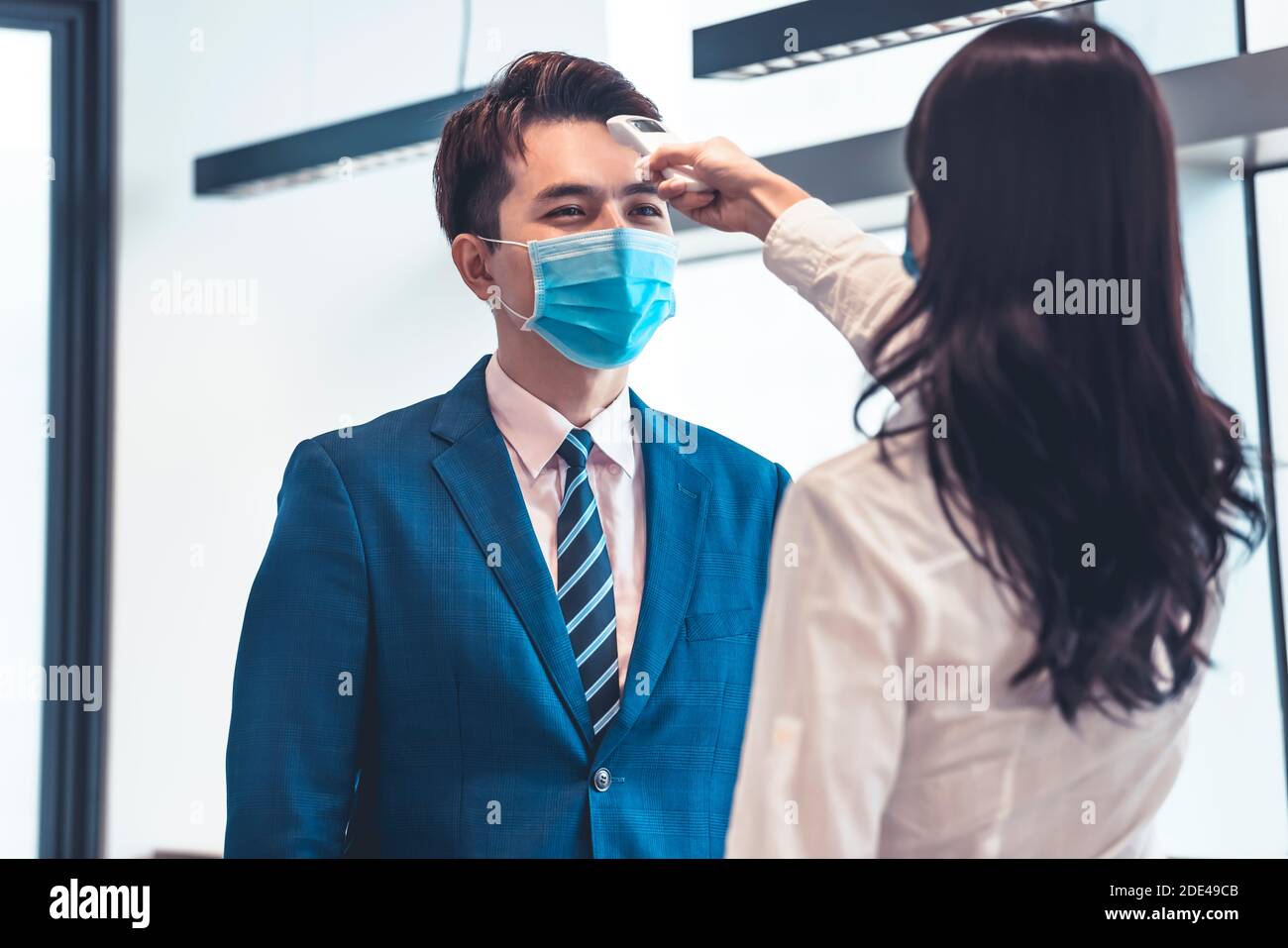 Business people check temperature measurement by infrared digital ...