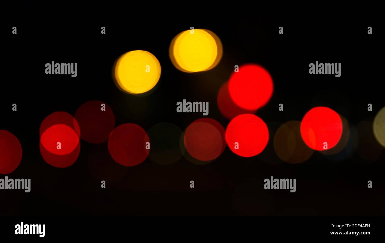 Abstract dark background with sparkling yellow and red lights ...