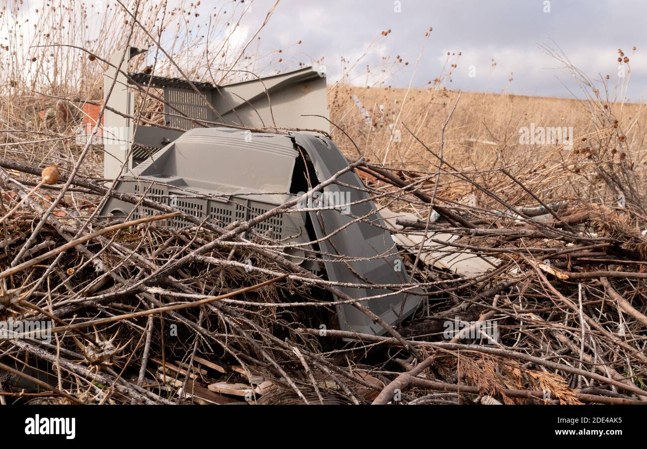 A pile of discarded trash and branches at a field Stock Photo - Alamy