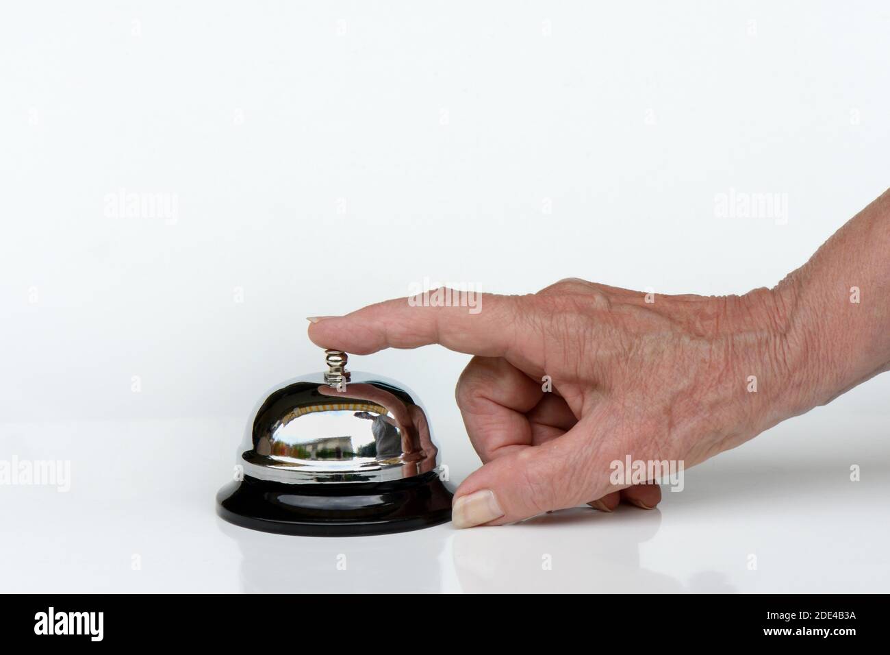 Hand rings table bell, Germany Stock Photo - Alamy