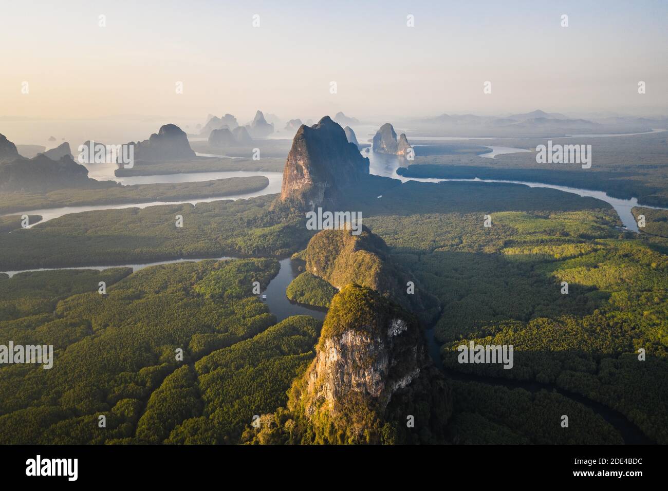 Aerial view, mangrove forest with meandering river and high karst rocks ...