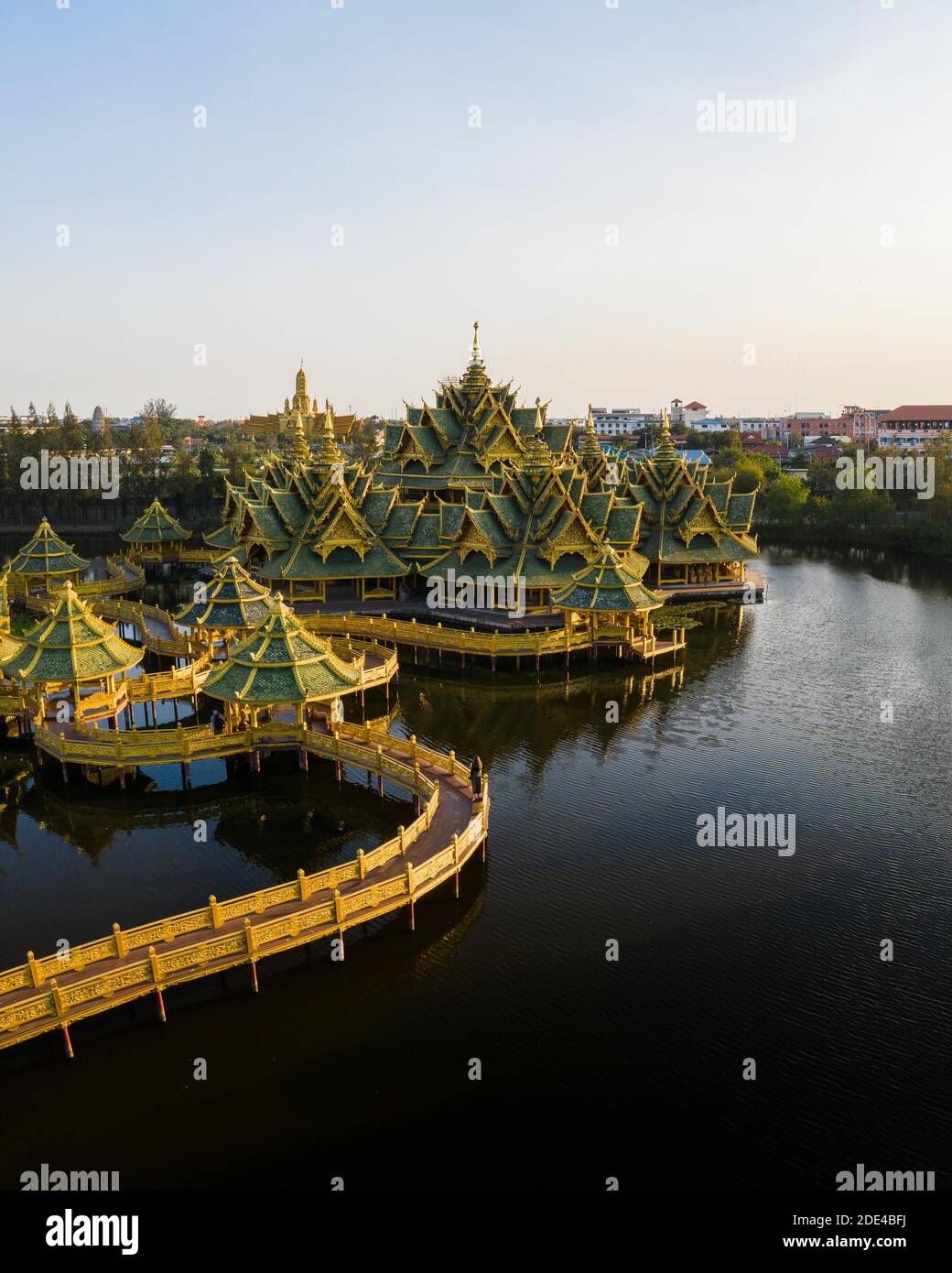 Aerial view, hexagonal golden temple from above with walking person ...