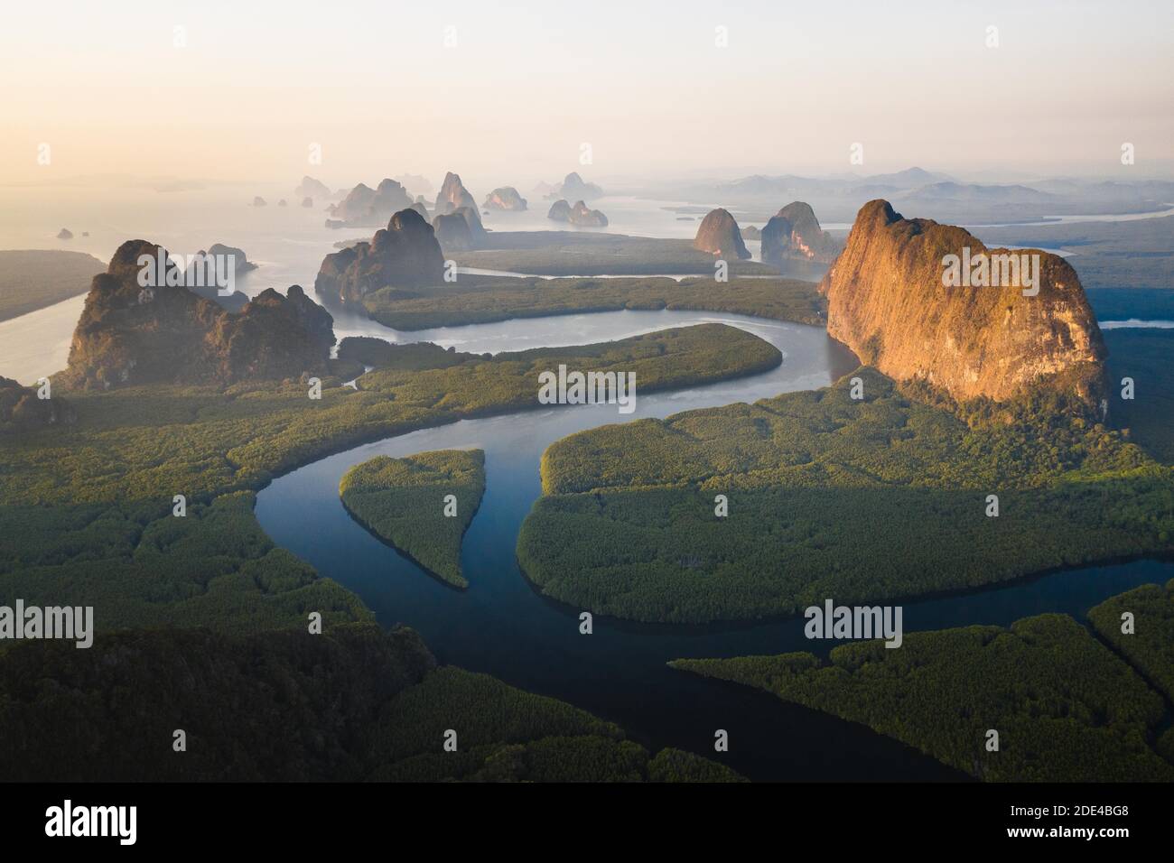 Aerial view, mangrove forest with meandering river and high karst rocks ...