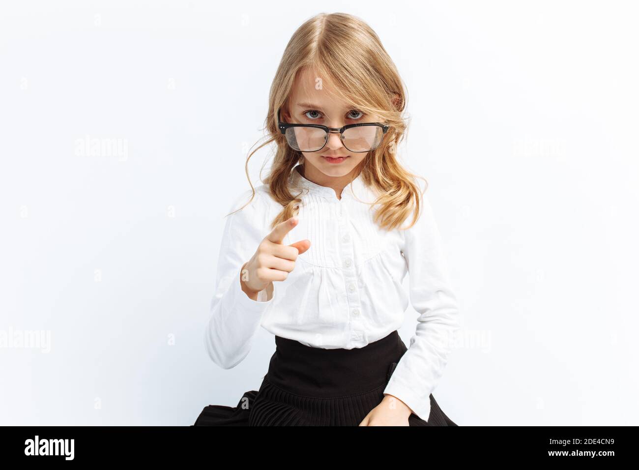 Little girl in the image of a strict teacher, glasses, isolated ...