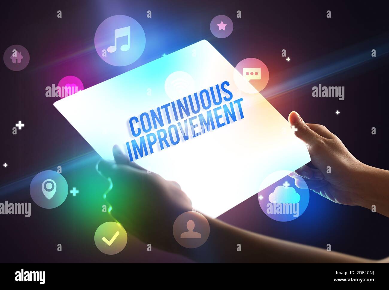 Holding futuristic tablet with CONTINUOUS IMPROVEMENT inscription, new ...