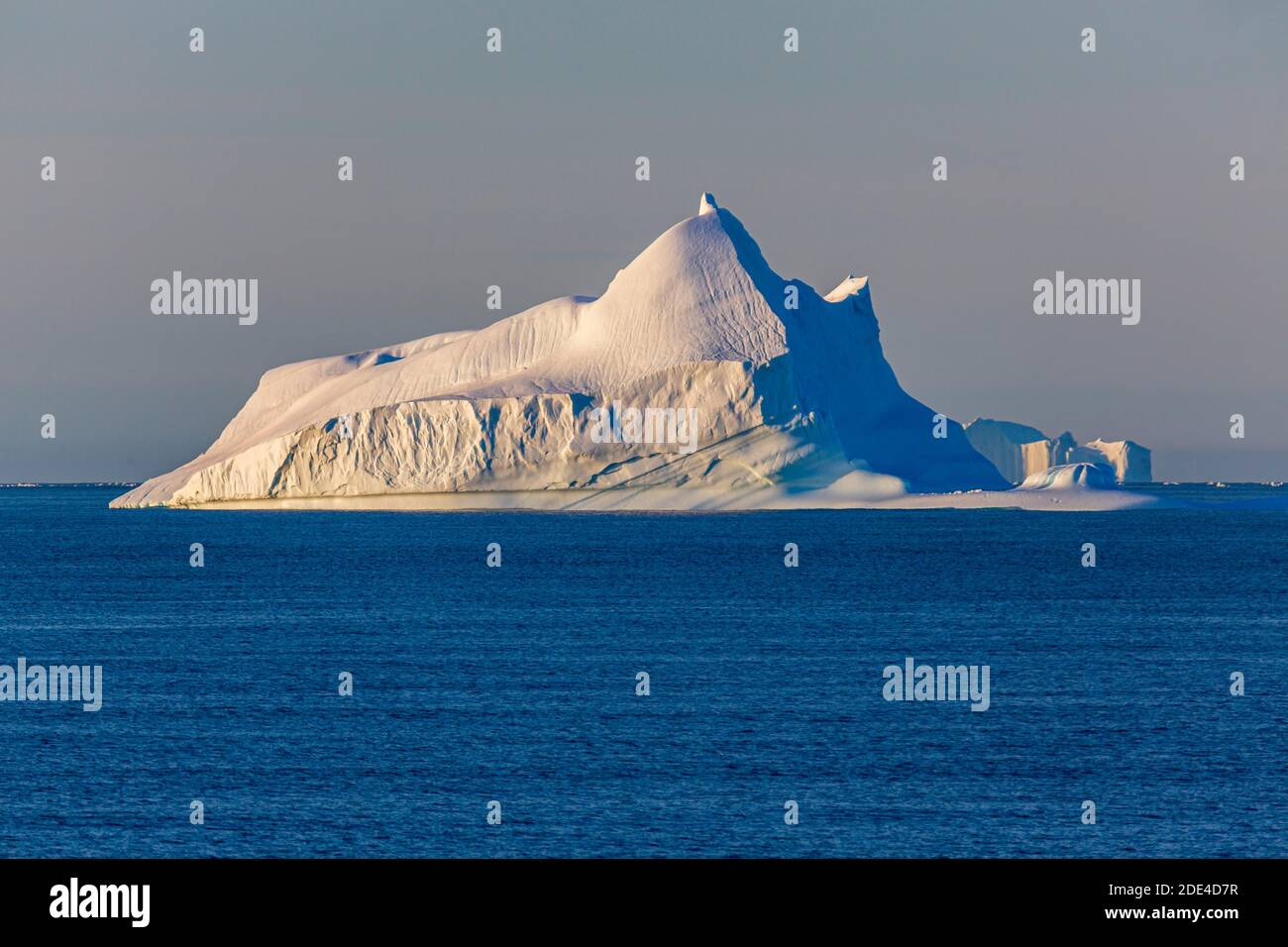 Iceberg in blue sea, east coast Greenland, Denmark Stock Photo - Alamy