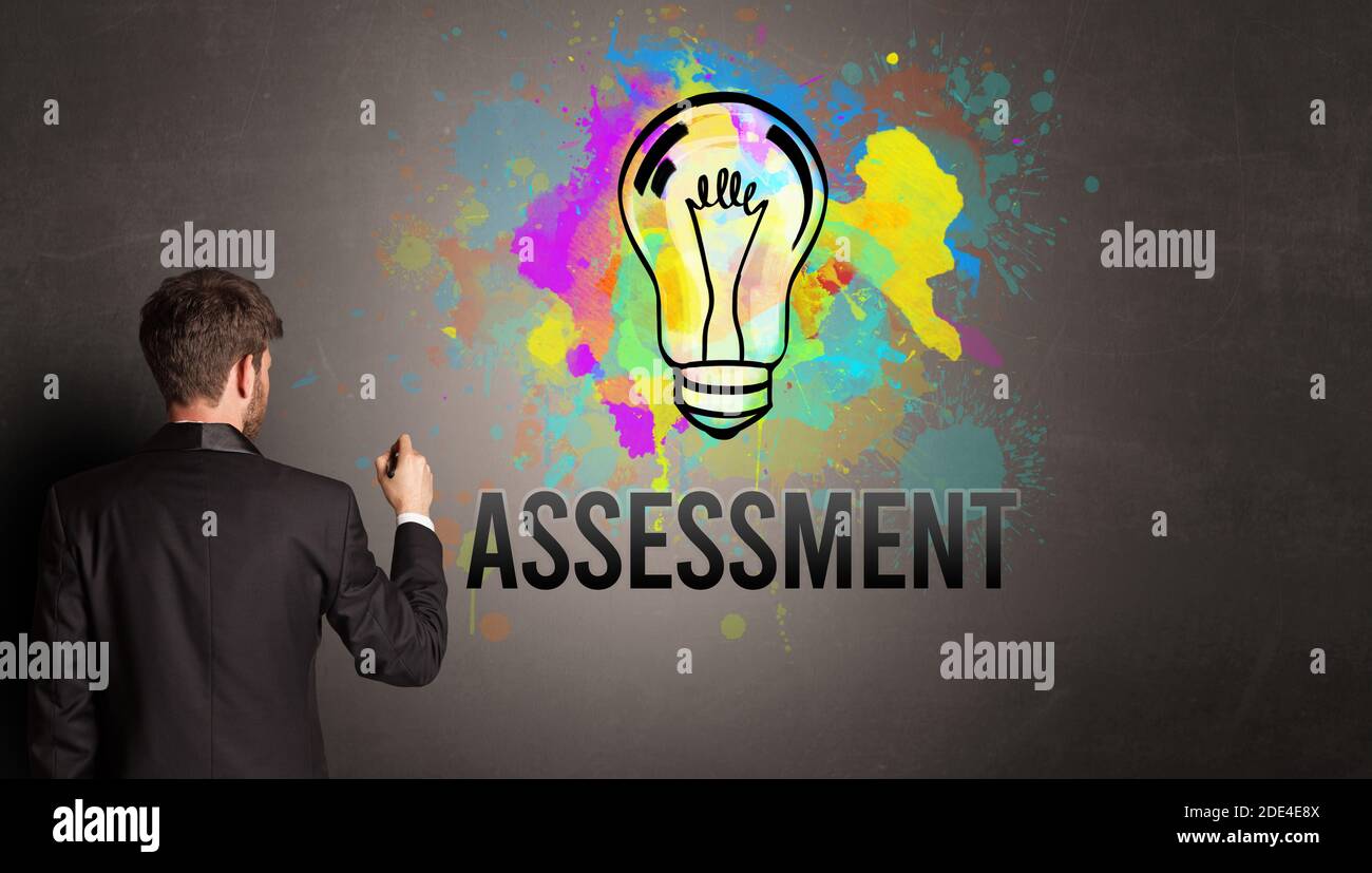 businessman drawing colorful light bulb with ASSESSMENT inscription on ...