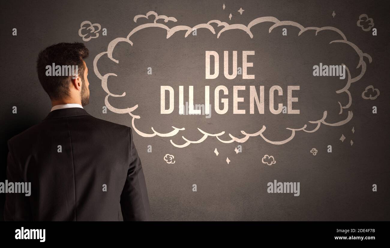 businessman drawing a cloud with DUE DILIGENCE inscription inside ...