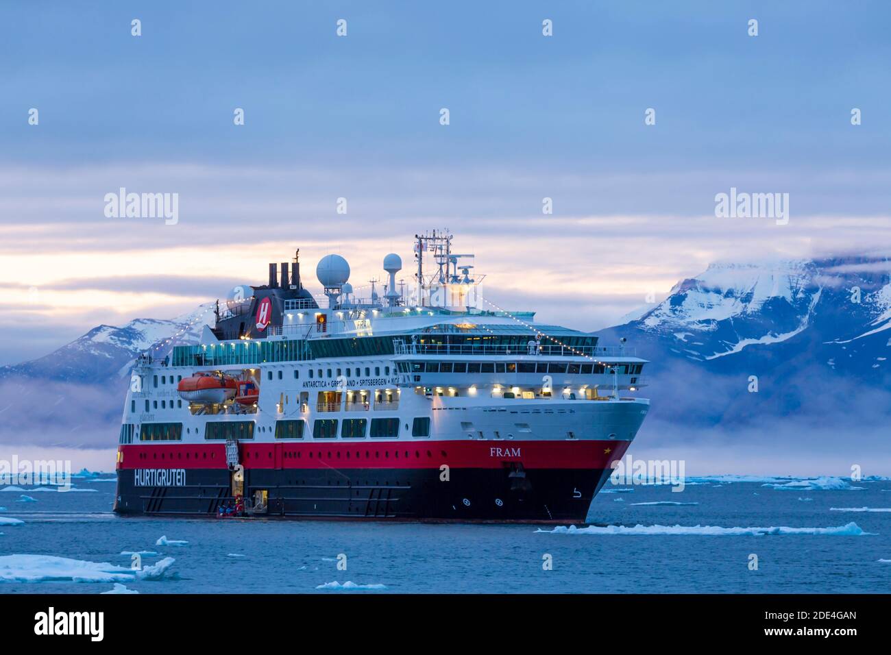Cruise ship in ice field, evening mood, fjord, east coast of Greenland ...