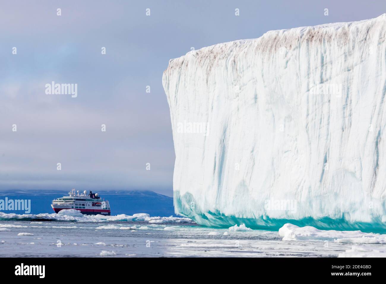 Cruise ship behind iceberg, East coast of Greenland, Denmark Stock ...