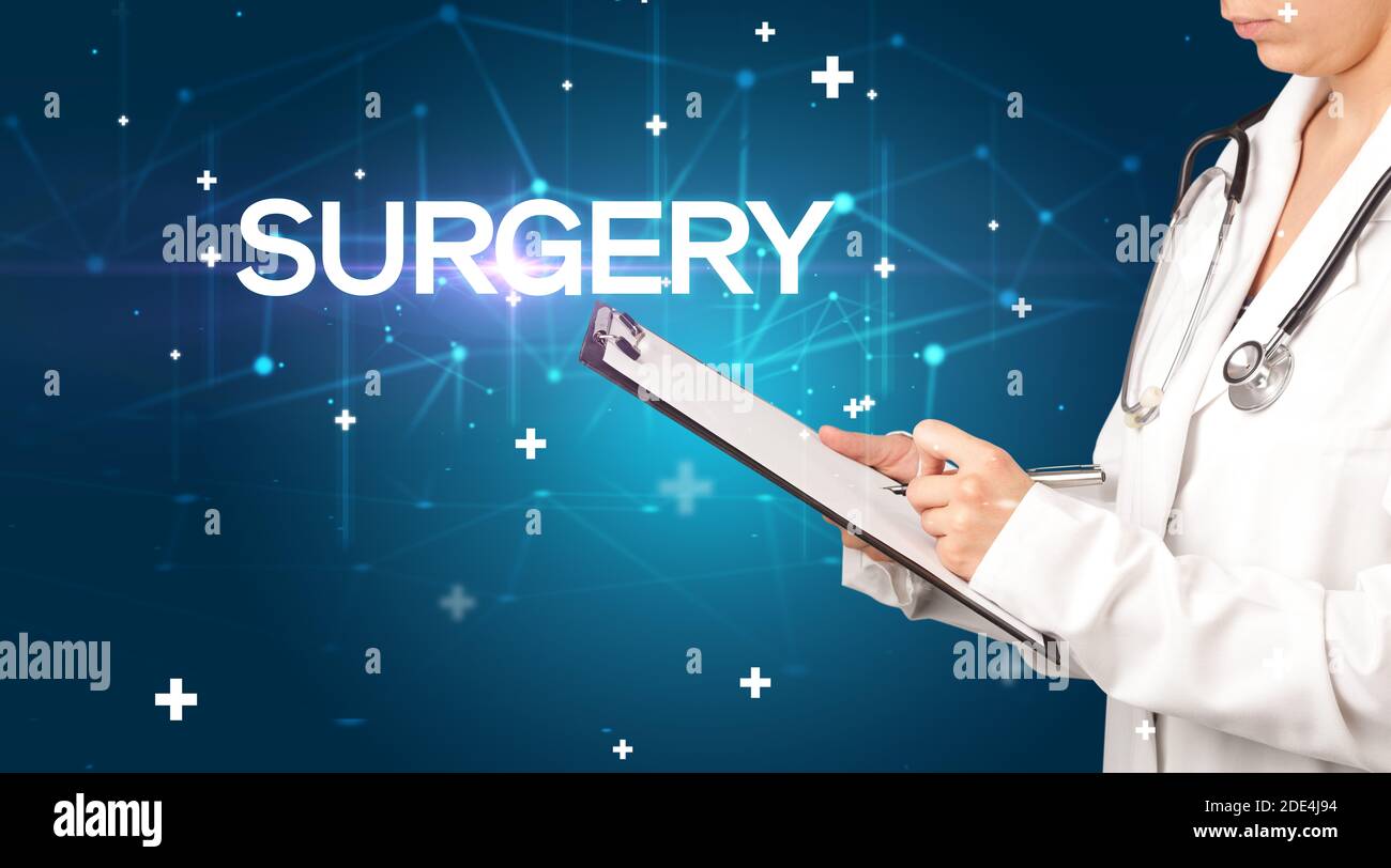 Doctor fills out medical record with SURGERY inscription, medical ...