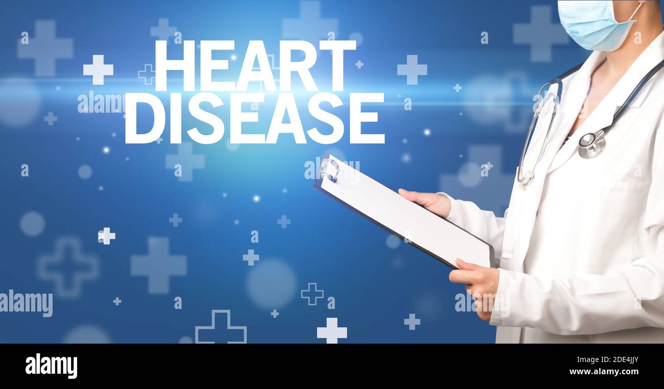 doctor writes notes on the clipboard with HEART DISEASE inscription ...