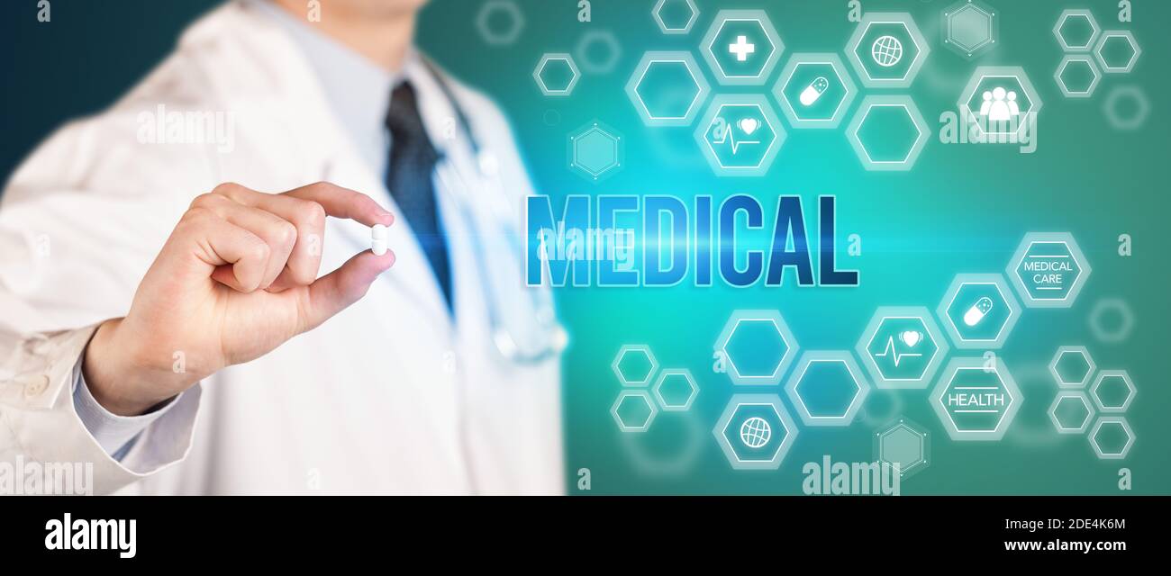 Close-up of a doctor giving you a pill with MEDICAL inscription ...