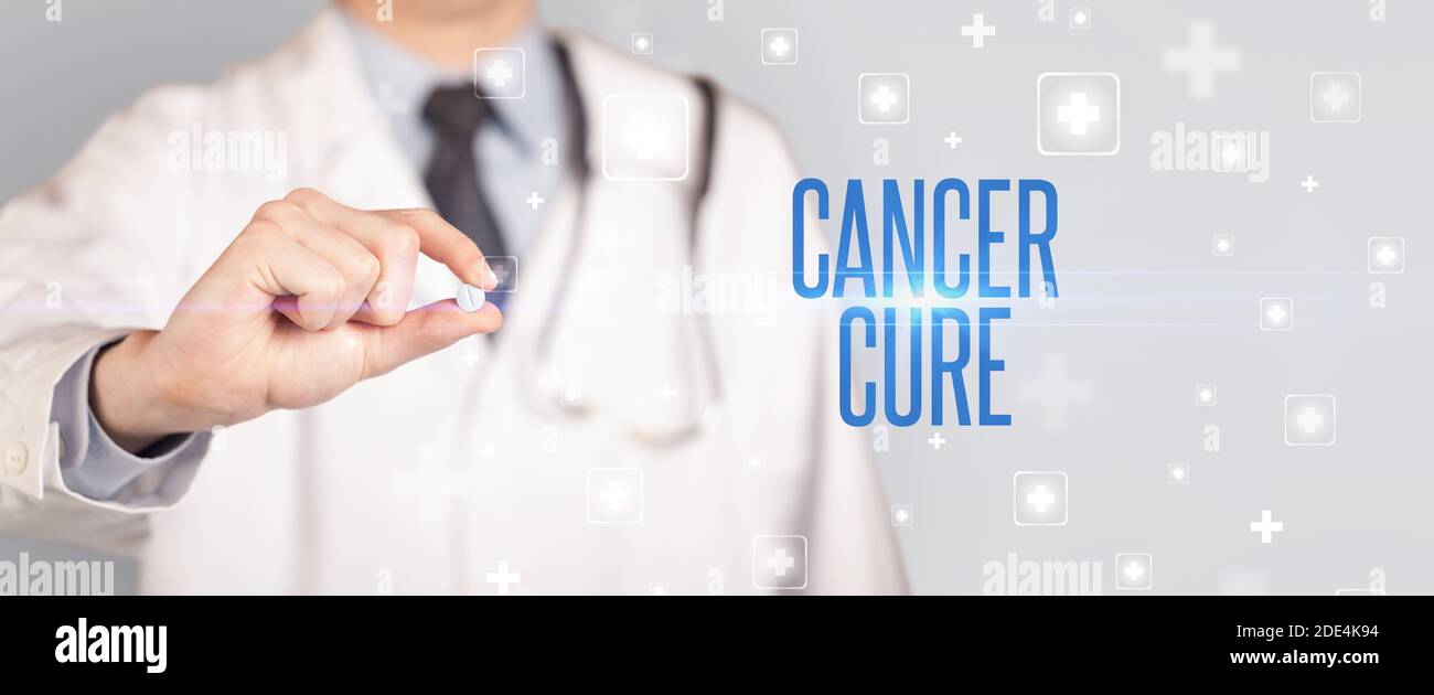 Close-up of a doctor giving a pill with CANCER CURE inscription ...