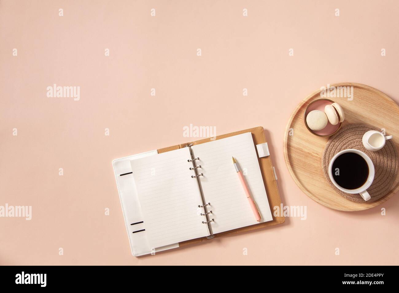 Top view of coral colored diary 2021, pen case, gift boxes, o'clock and ...