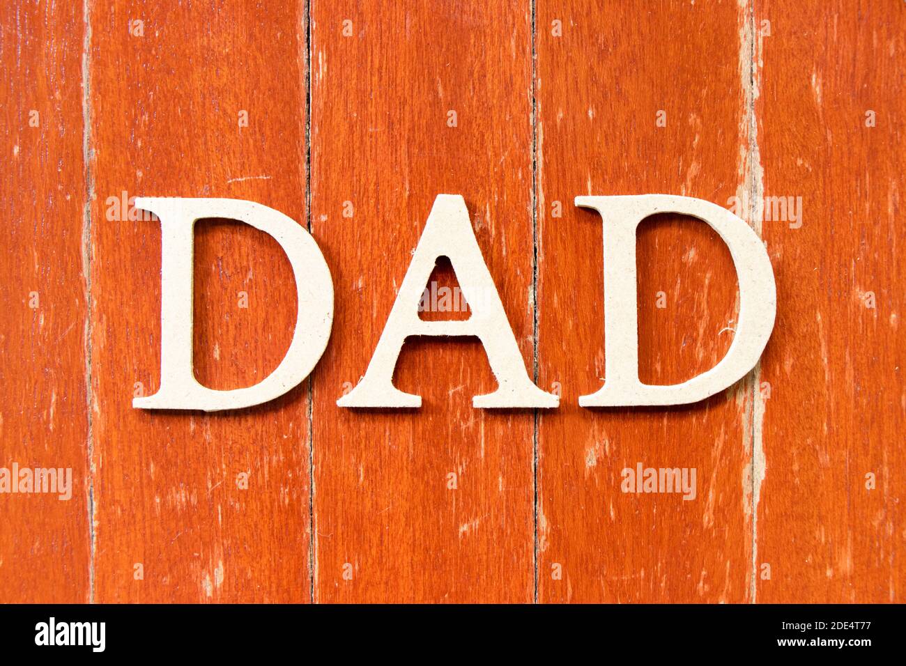 Alphabet letter in word dad on old red color wood plate background ...