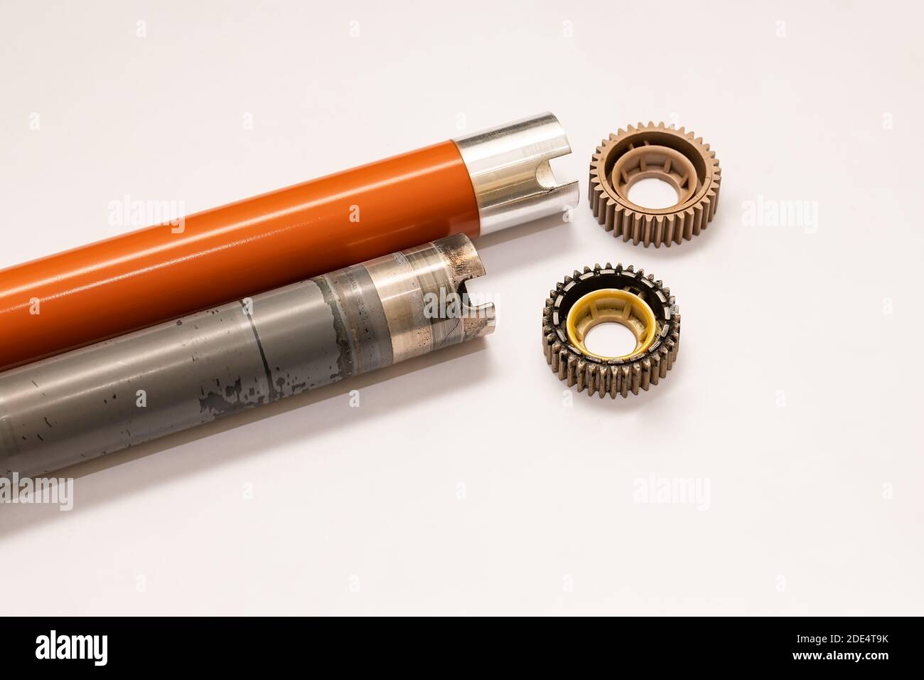 comparison of two Teflon shafts from a laser printer and gears, a new ...