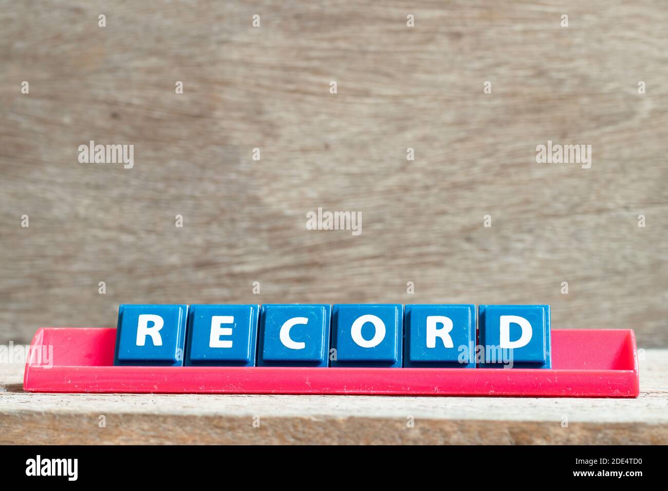 Tile letter on red rack in word record on wood background Stock Photo ...