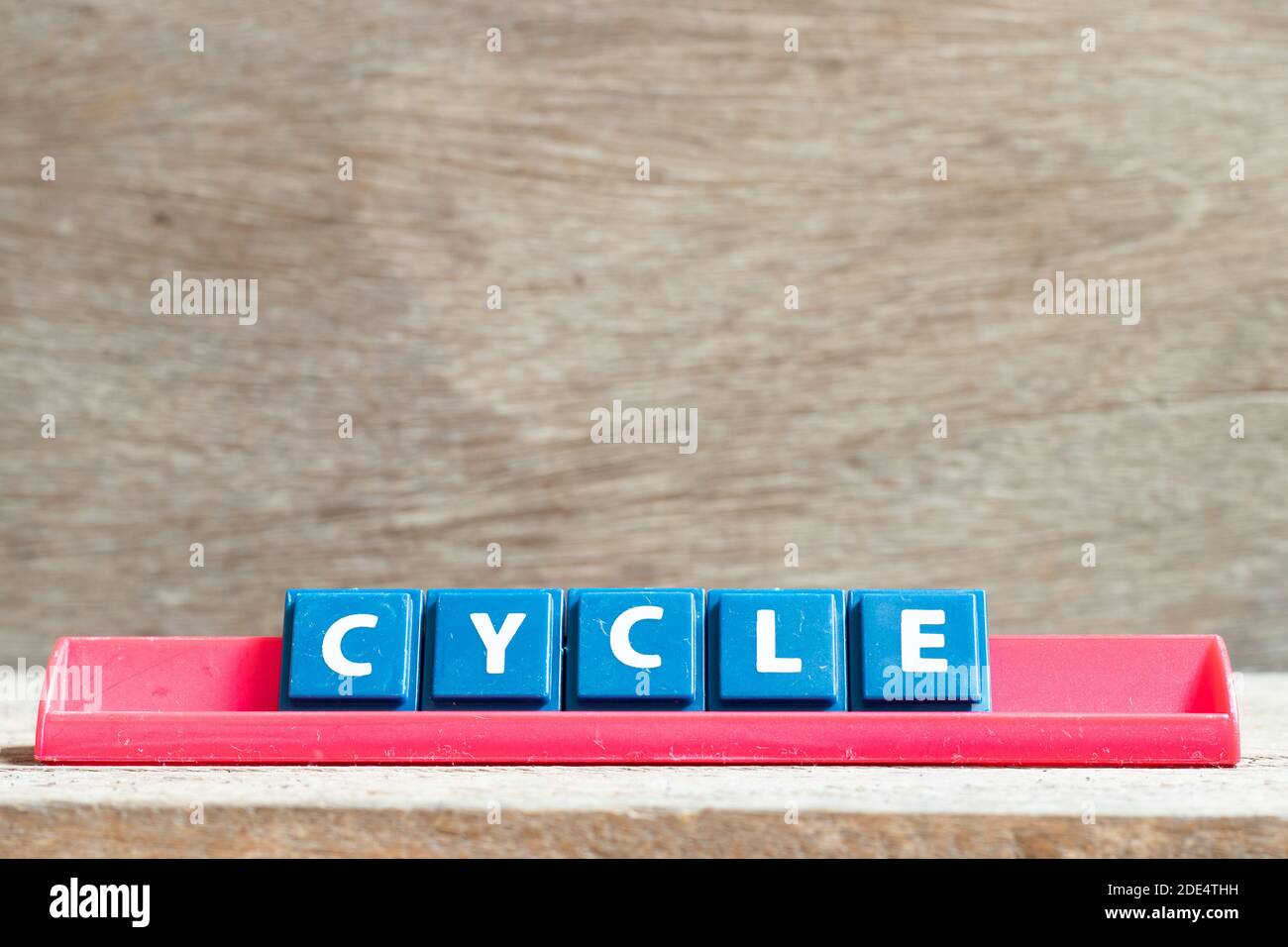 Tile letter on red rack in word cycle on wood background Stock Photo ...
