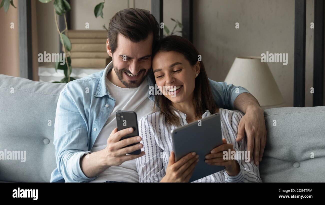 Family using electronic gadgets hi-res stock photography and images - Alamy