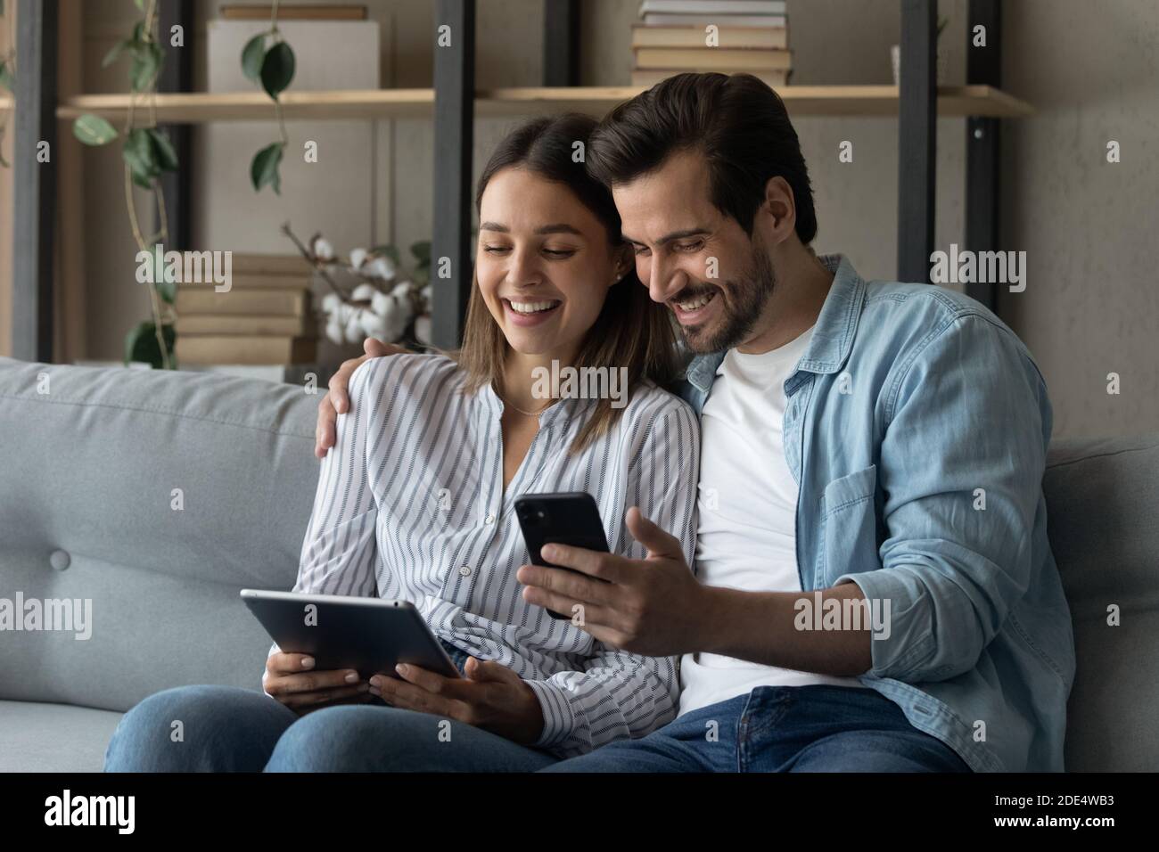 Family using electronic gadgets hi-res stock photography and images - Alamy