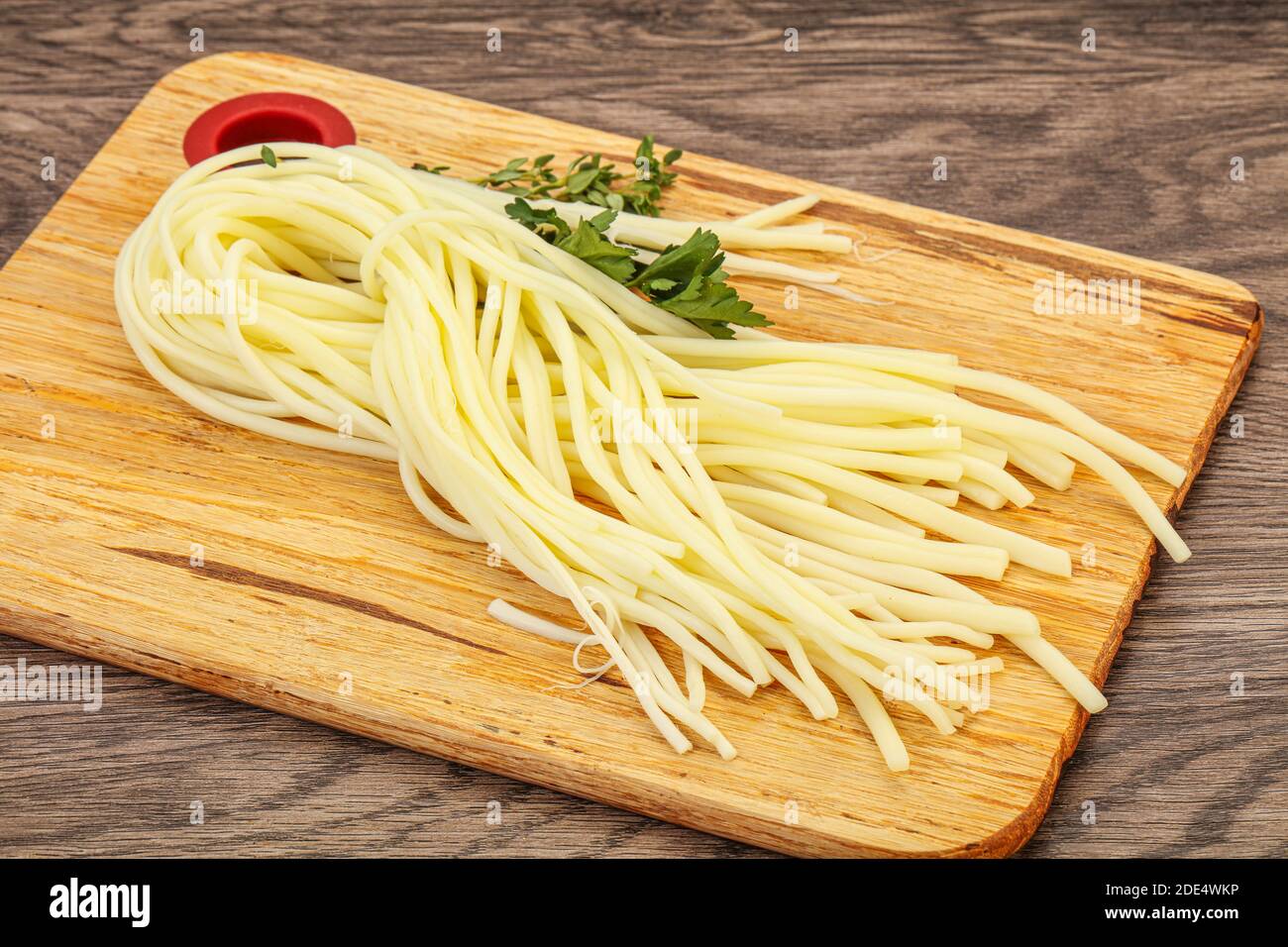 Chechil spaghetti cheese snack over board Stock Photo - Alamy