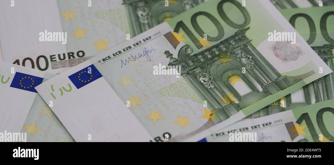 many 100 euro banknotes on a table Stock Photo - Alamy