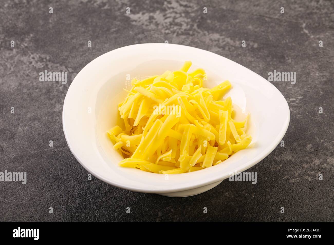 Shredded yellow cheese in the bowl for cooking Stock Photo - Alamy