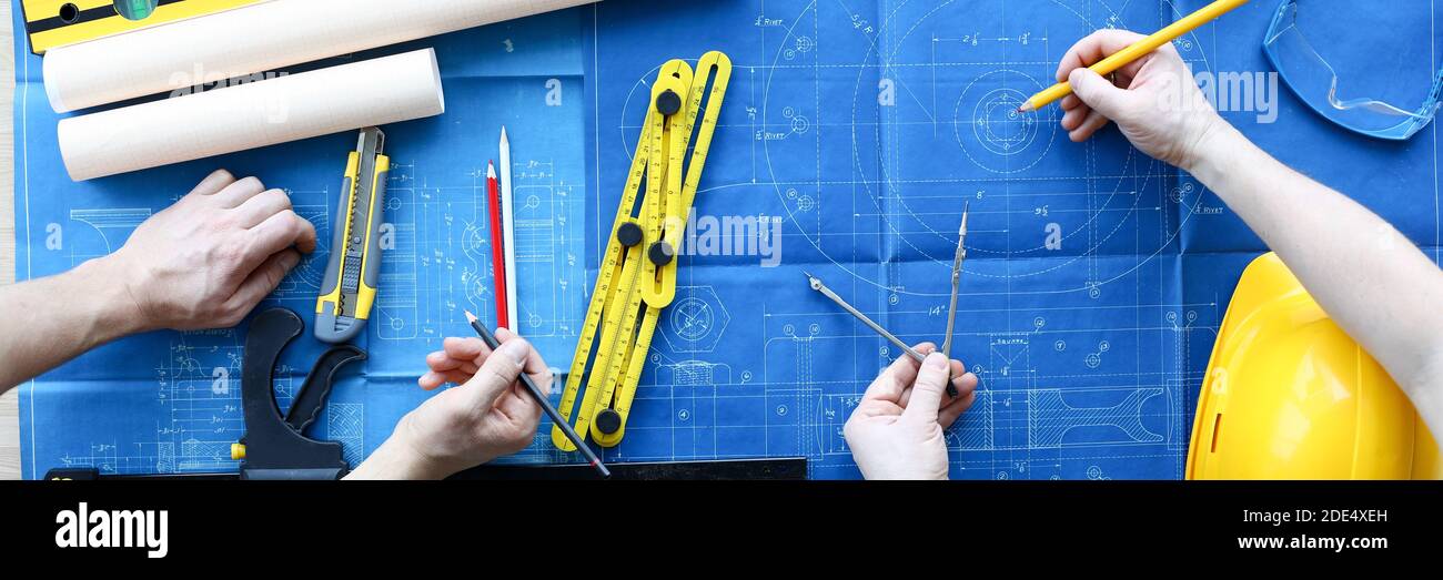 Men draftsmen on table draw construction project Stock Photo - Alamy