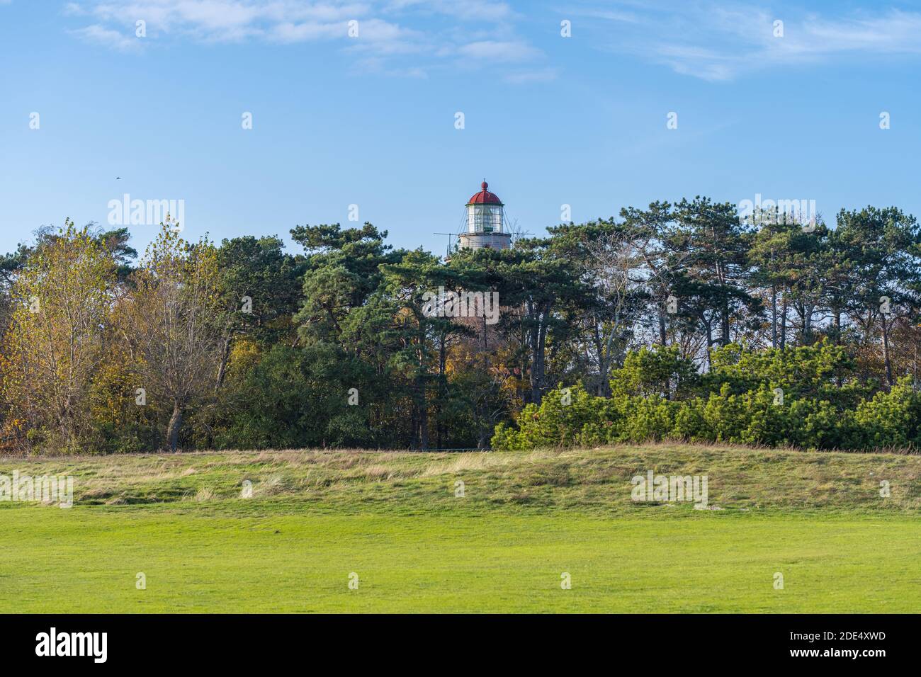 A brick lighthouse with a bright blue sky in the background. Picture of ...
