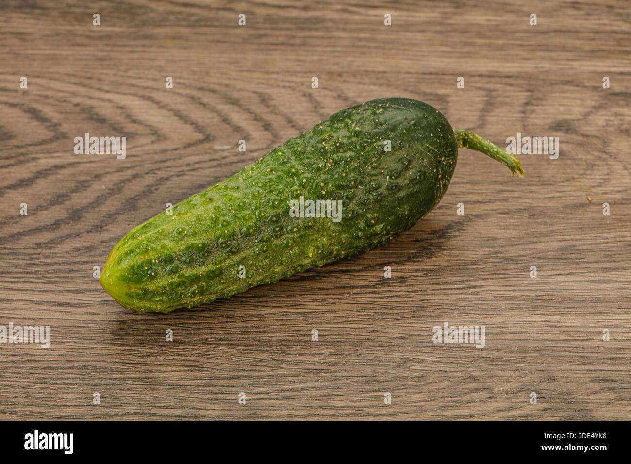 Green ripe fresh one cucumber over background Stock Photo - Alamy