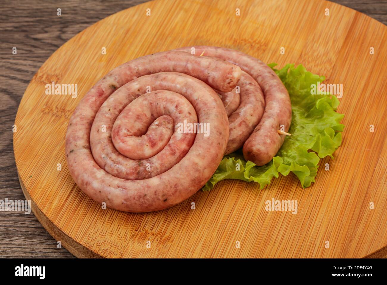 Raw pork sausage ring for grill Stock Photo - Alamy