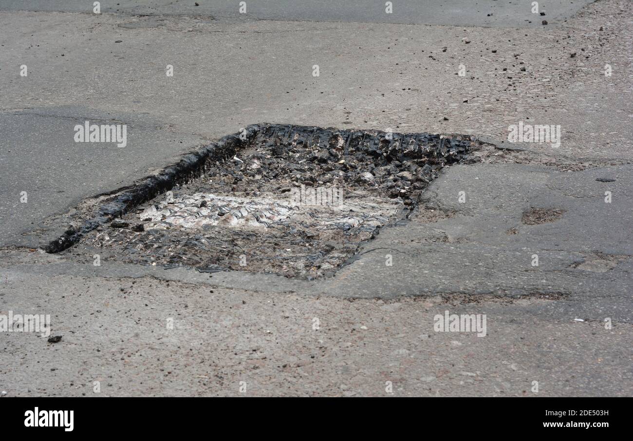 Repair asphalt road pavement hole and laying new asphalt patching ...