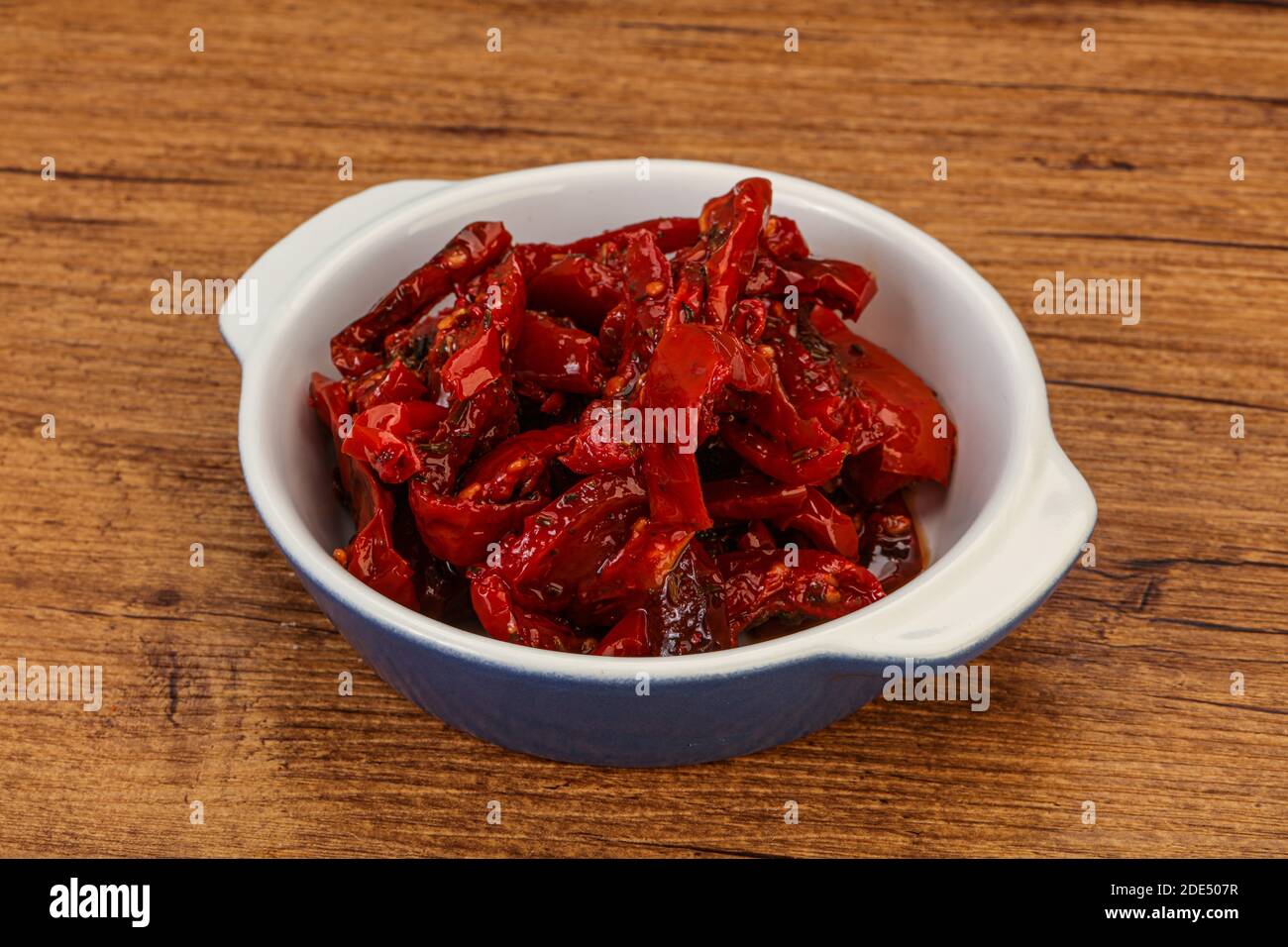 Dried tomato with olive oil and herbs Stock Photo - Alamy