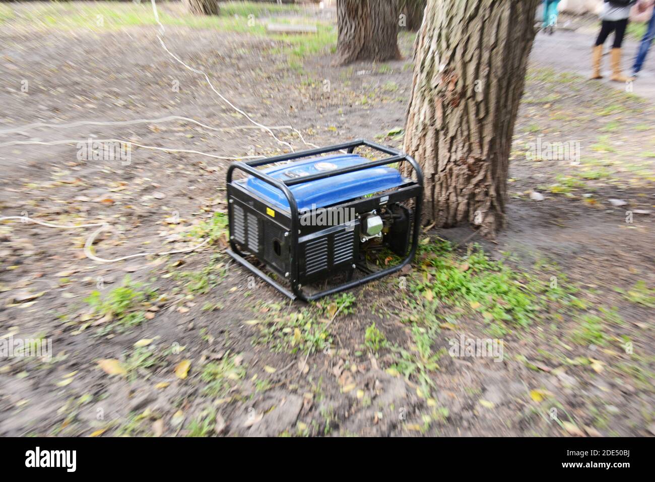 A backup portable generator is producing power, electricity outdoors ...