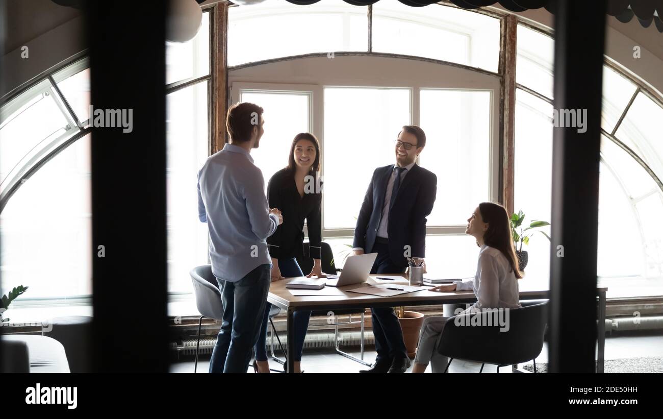 Diverse multiethnic coworkers having fun on seminar at conference room ...