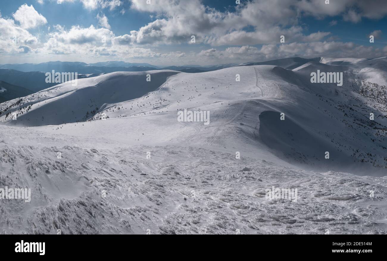 Snow and wind formed ice formations covered winter mountain plateau ...