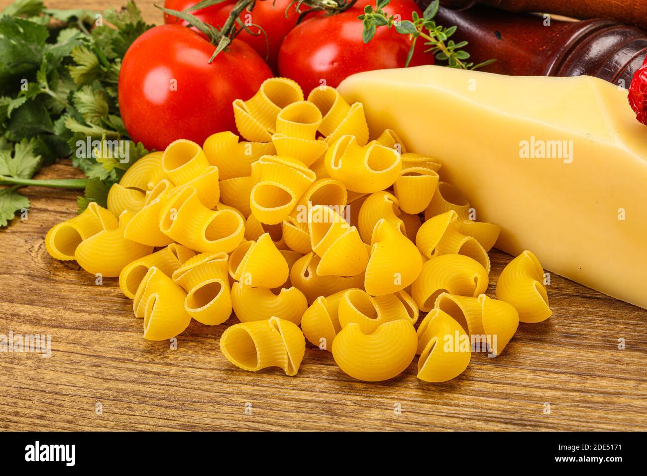 Italian pasta - raw pipe rigate served vegetables Stock Photo - Alamy