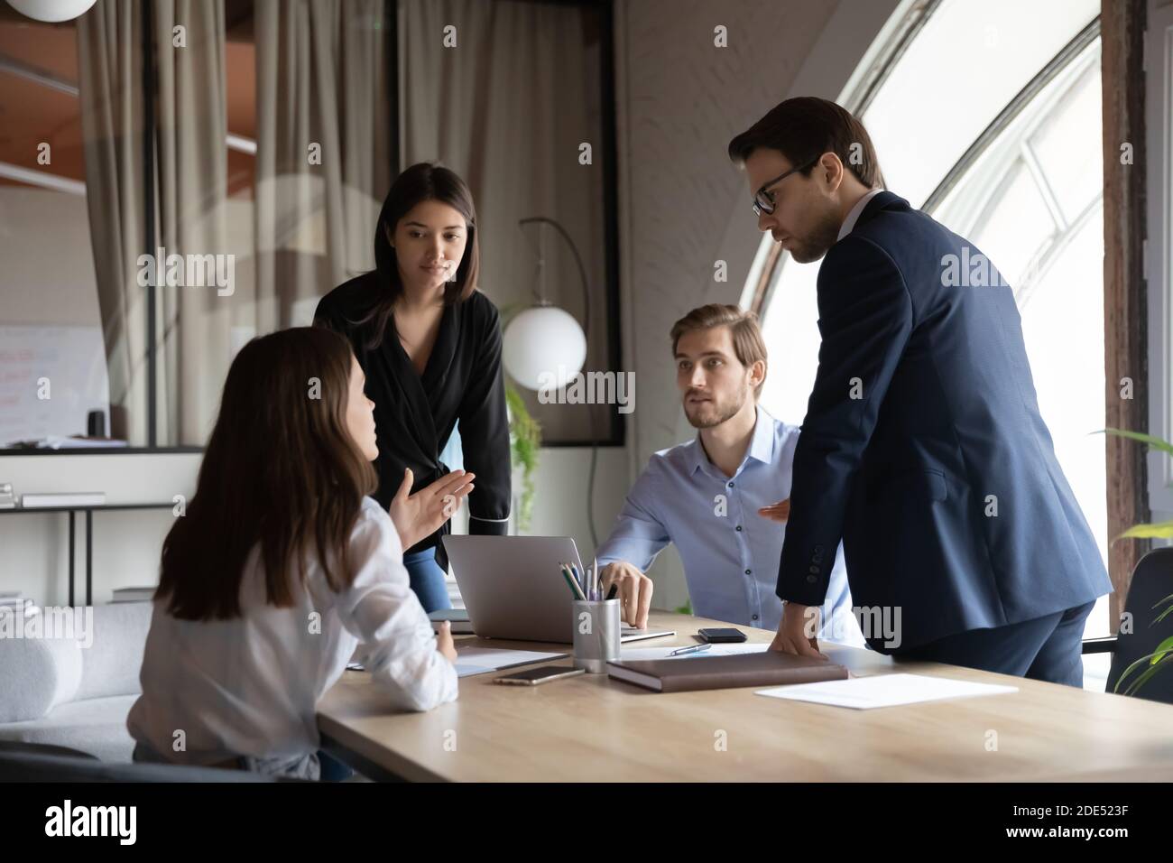 Multicultural millennial colleagues having talk discussion on formal ...