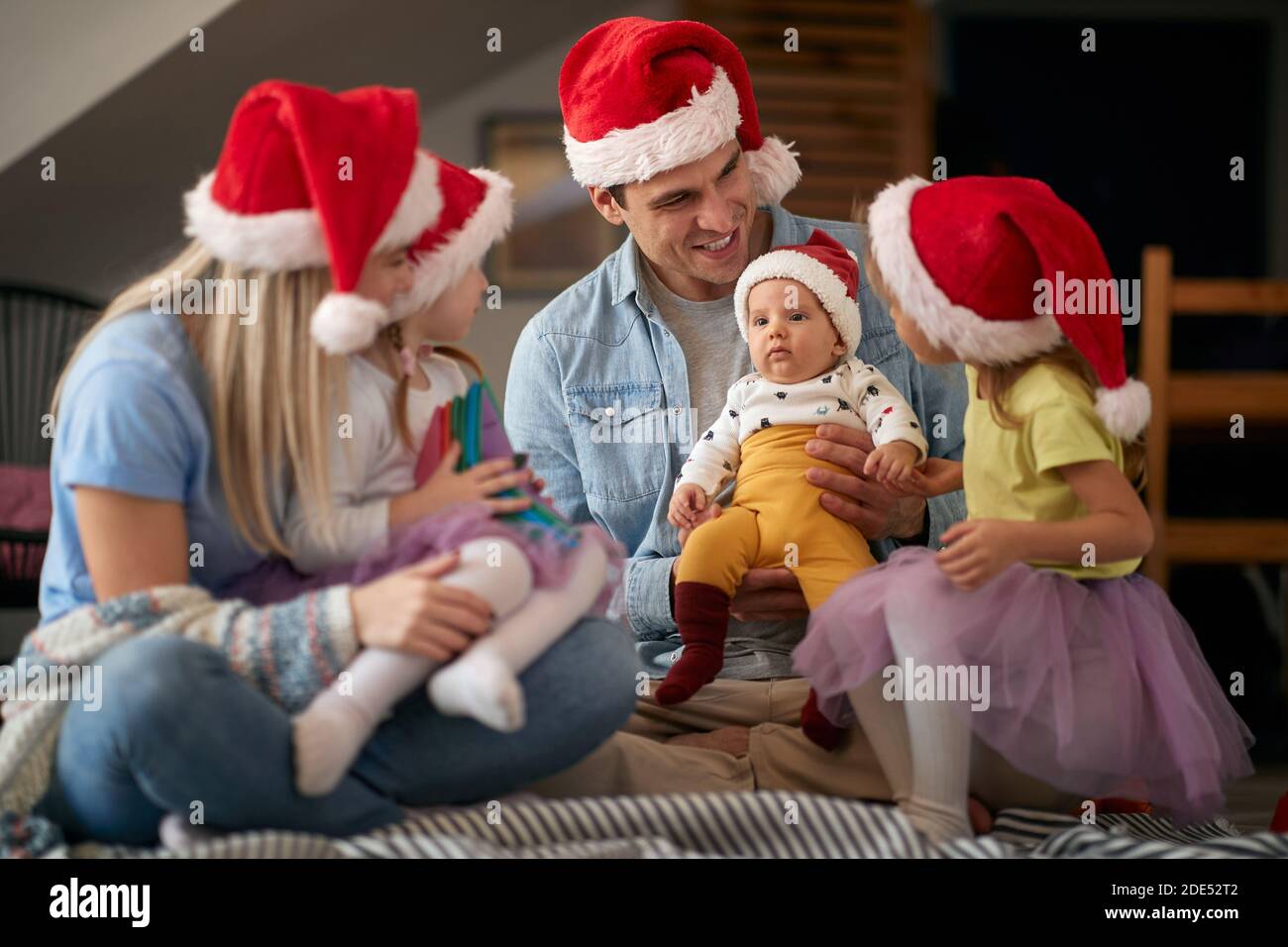 Joyful parents spening Christmas time together with their kids Stock ...