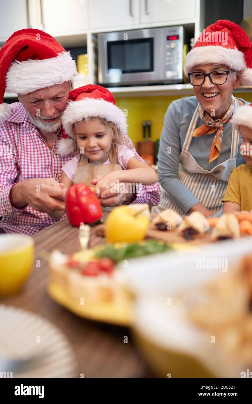 Grandchildren at the kitchen in a festive atmosphere learning how to ...