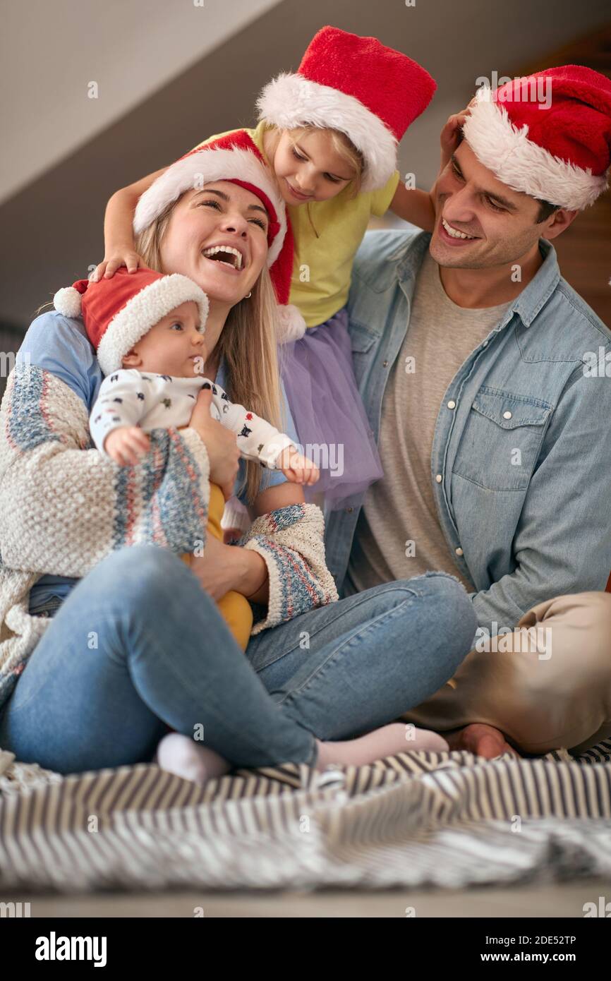 Happy parents spening Christmas time together with their kids Stock ...