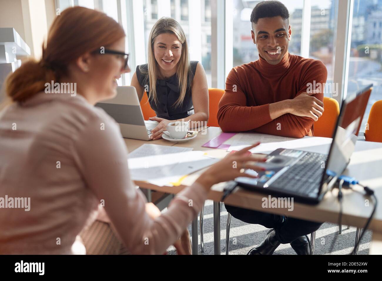 A young business woman presenting her work to a company commission in a ...