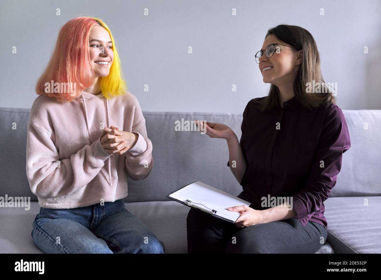 Teen girl giving interview to social worker. School psychologist ...