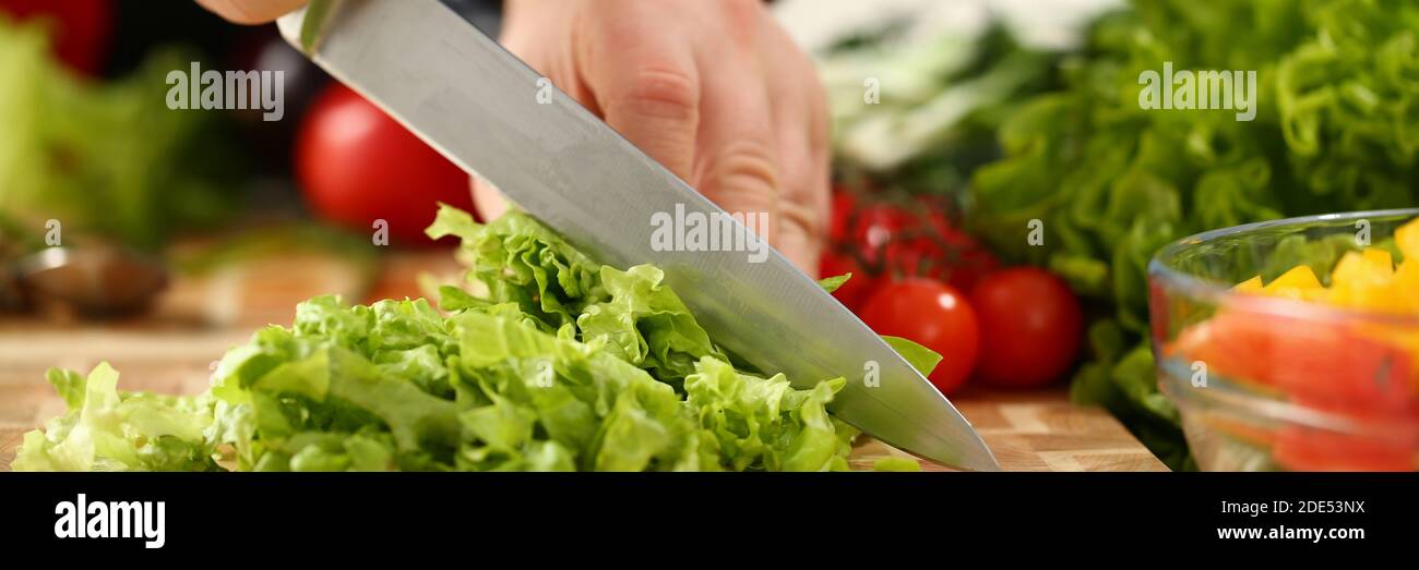 Professional cook cutting salad on the board Stock Photo - Alamy