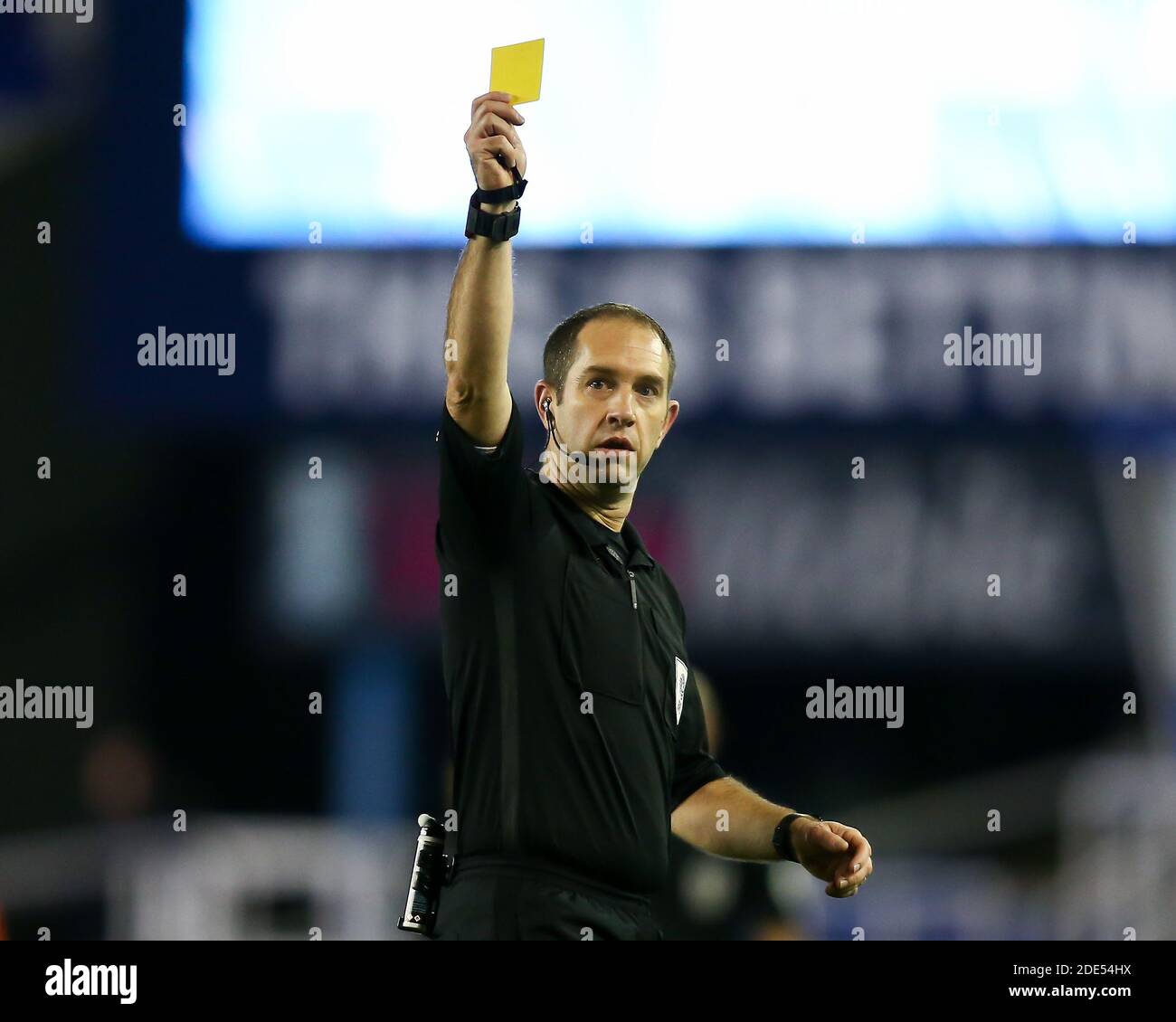 Referee Jeremy Simpson shows a yellow card Stock Photo - Alamy
