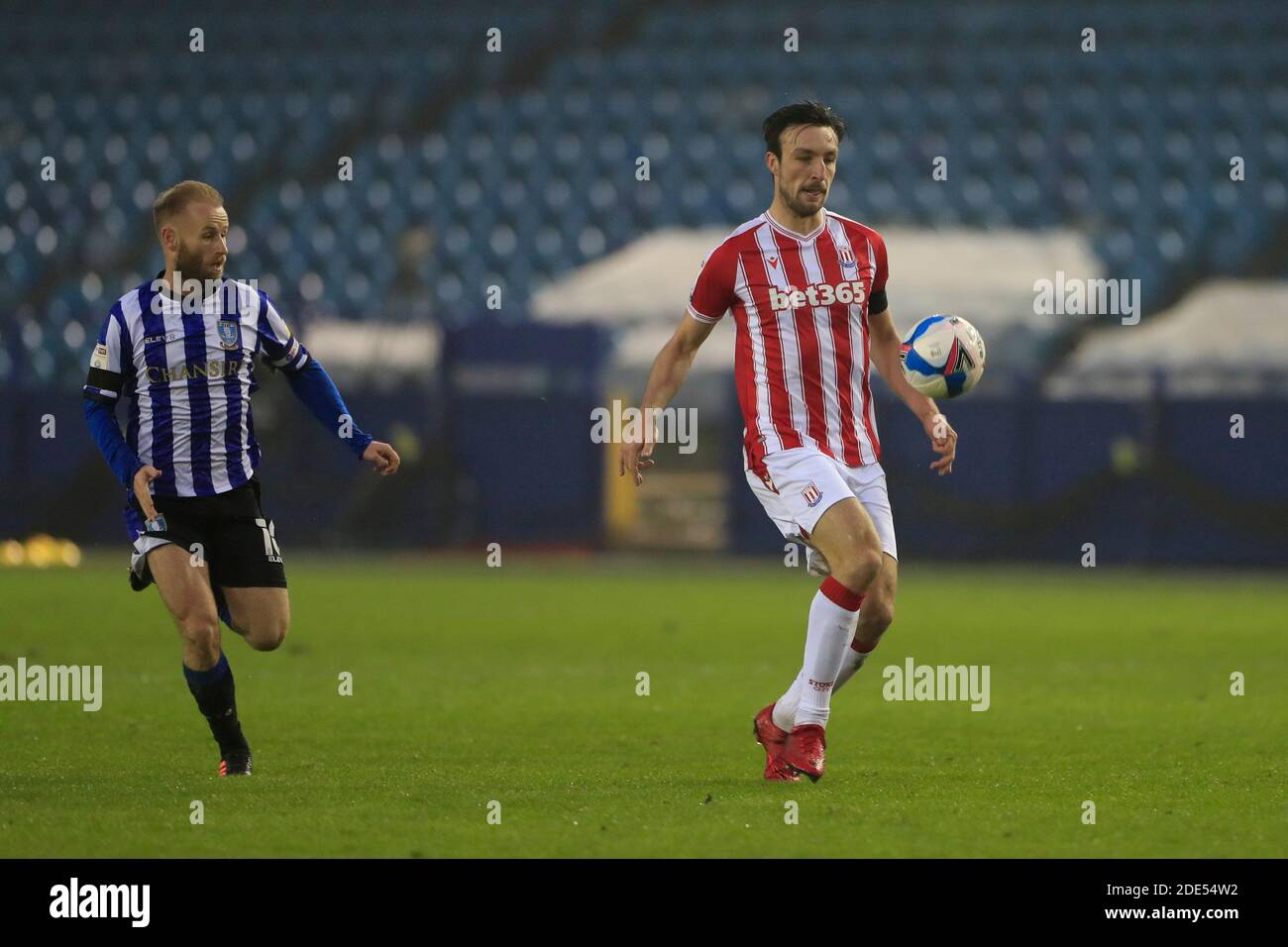 Morgan Fox #3 of Stoke City controls the ball chased by Barry Bannan ...