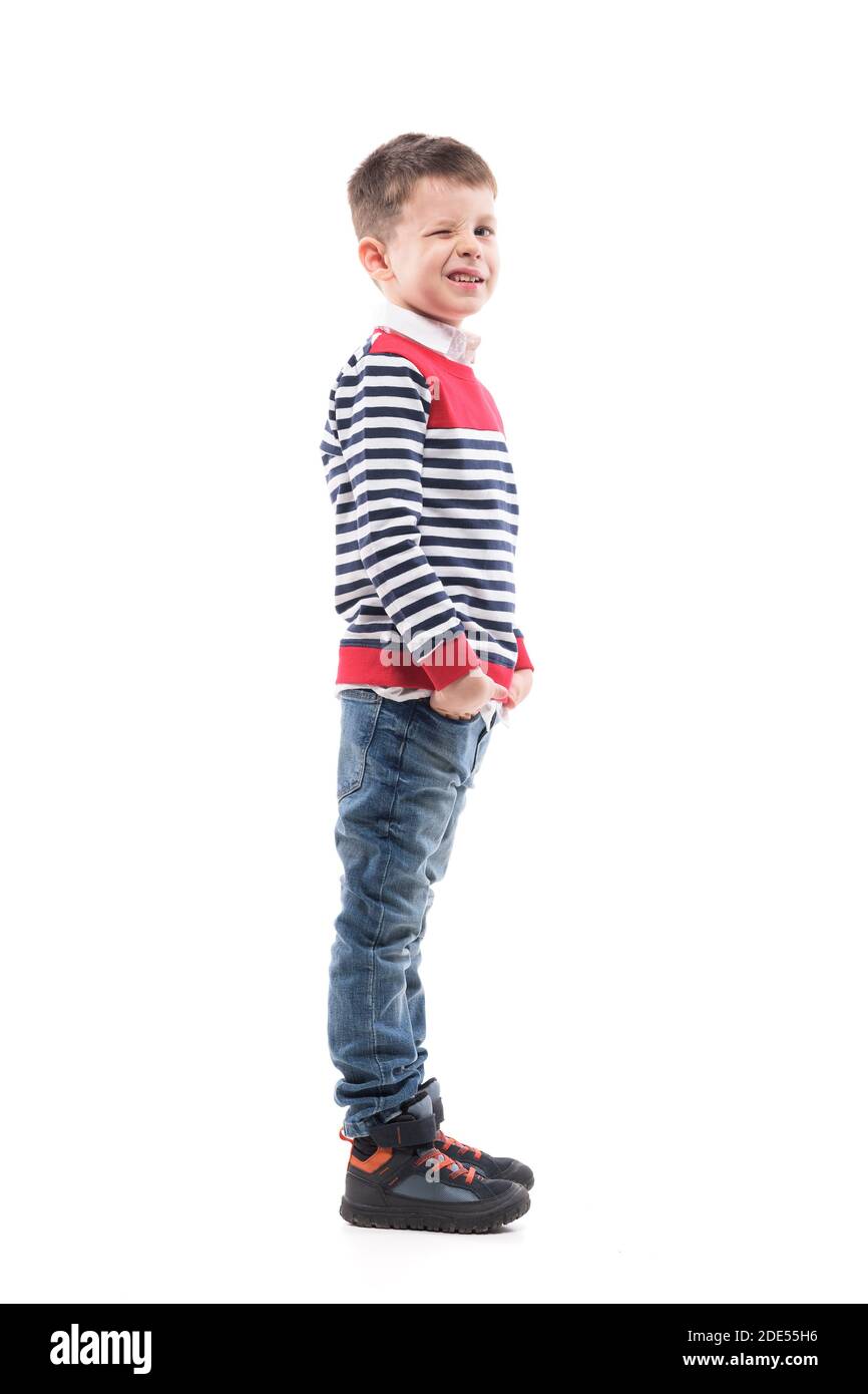 Side view of cute charming little kid turning and winking at camera ...